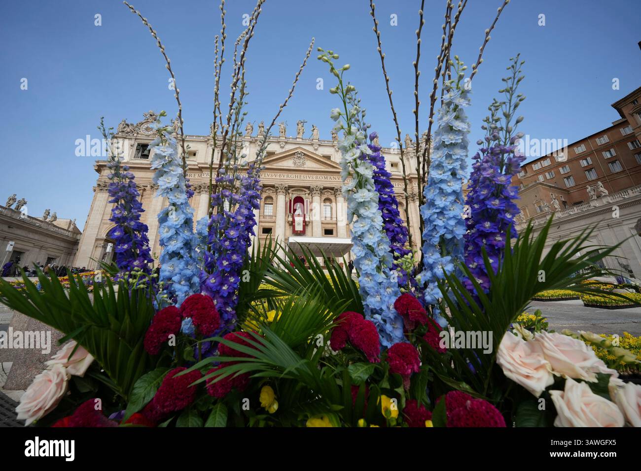 Flowers are set up for the Easter mass in St. Peter's Square at the ...
