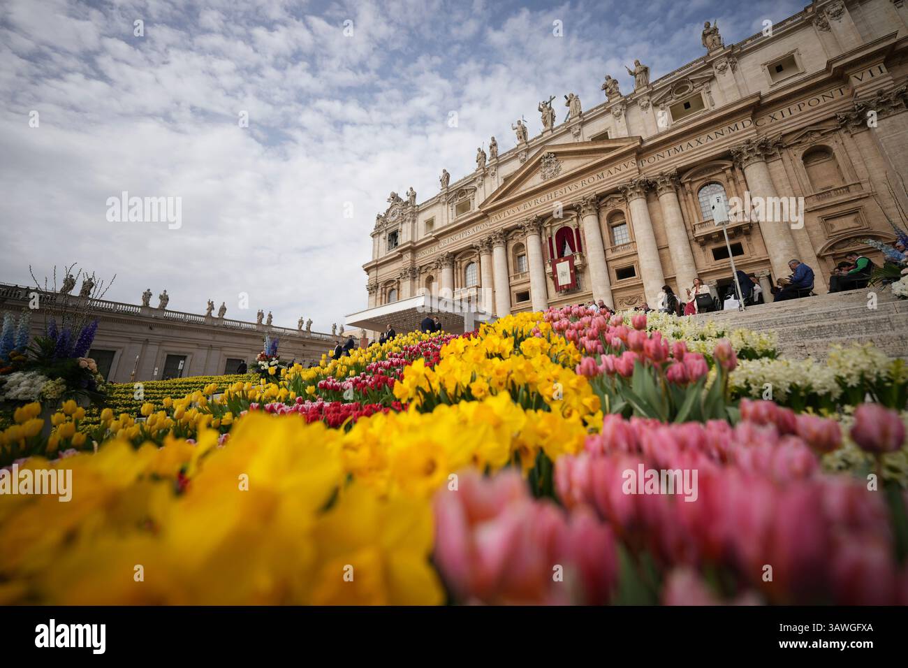Flowers are set up for the Easter mass in St. Peter's Square at the ...