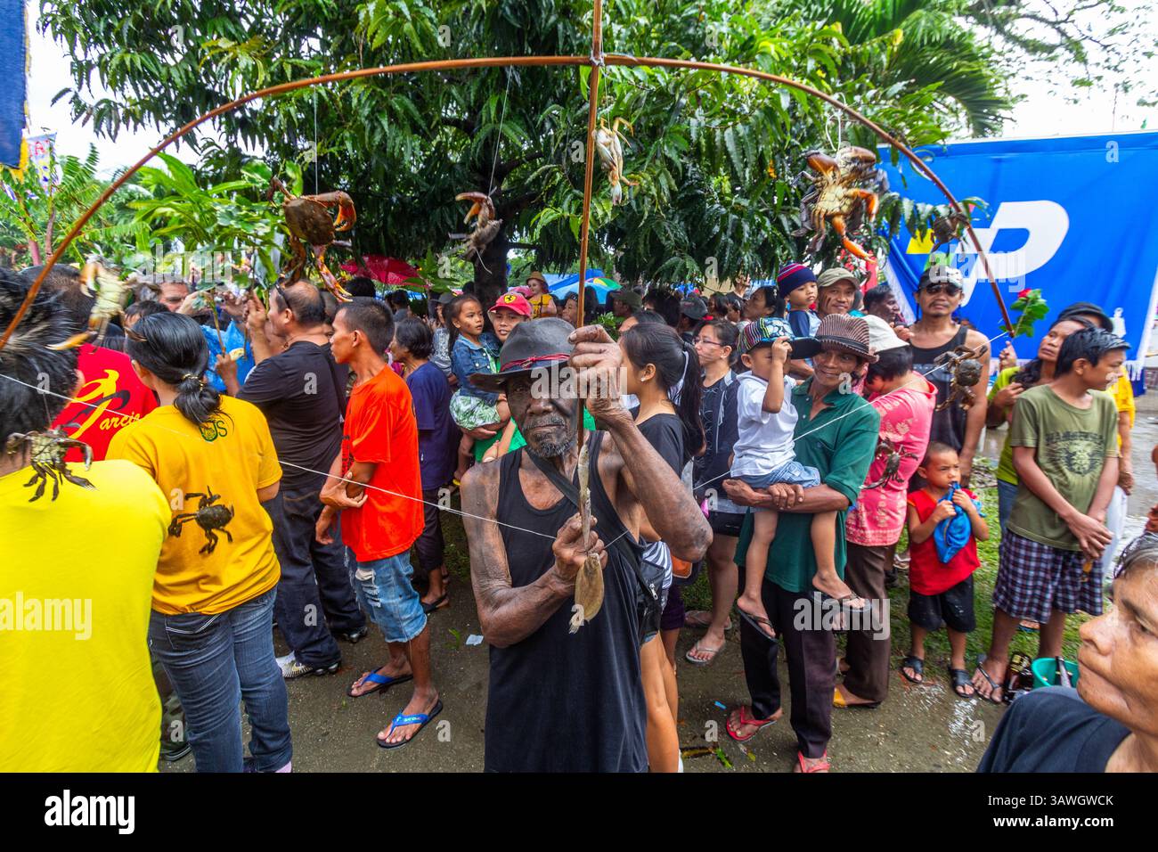 An old man in black paint holds a large bow and arrow adorned with ...