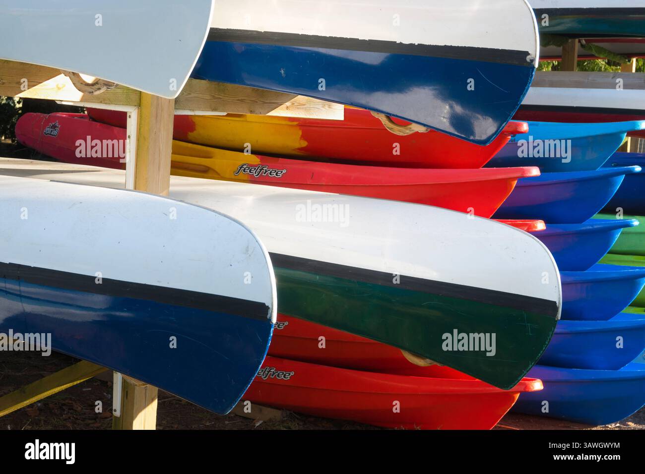 Brightly coloured canoes stacked on the boathouse of Nag's Head Island ...