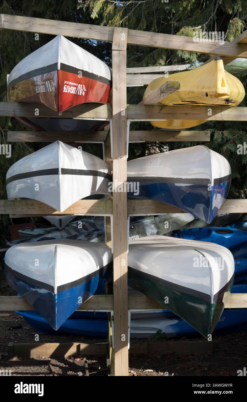 Brightly coloured canoes stacked on the boathouse of Nag's Head Island ...