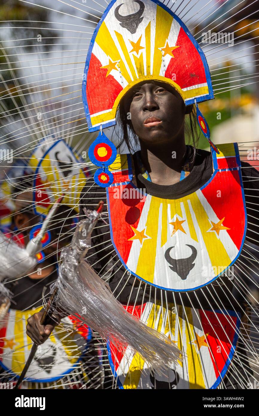 Participant in black face paint to honor the Ati tribe and wearing ...