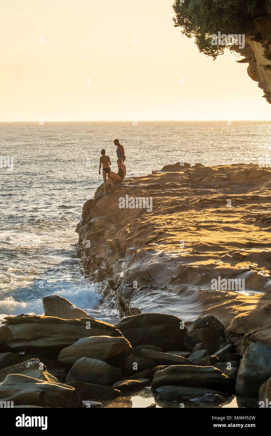 No.1 of a sequence of 4 images of women ocean swimmers prepare and then ...