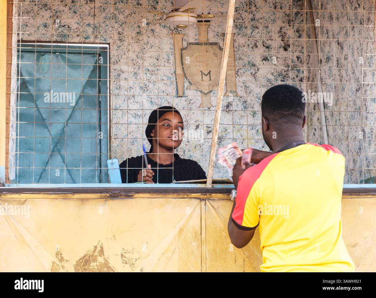 Sonyo, Ghana. Customer Handing Money to Attendant at Mobile Money Kiosk ...