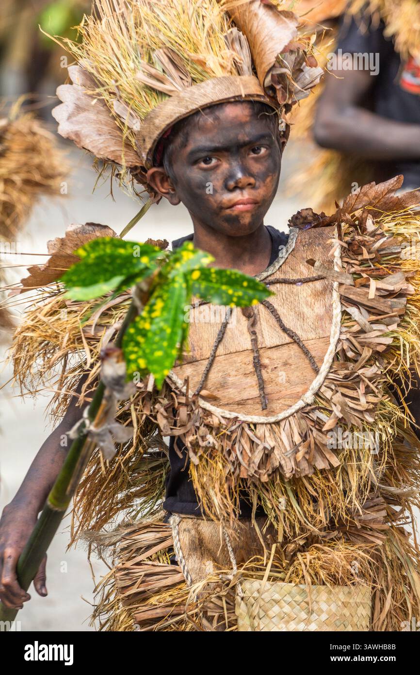 Participant in black face paint to honor the Ati tribe and wearing ...