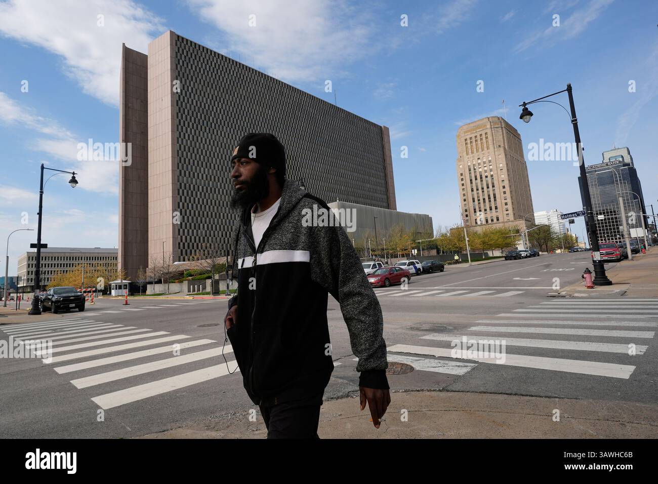 A pedestrian walks past the The Richard Bolling federal building, left ...