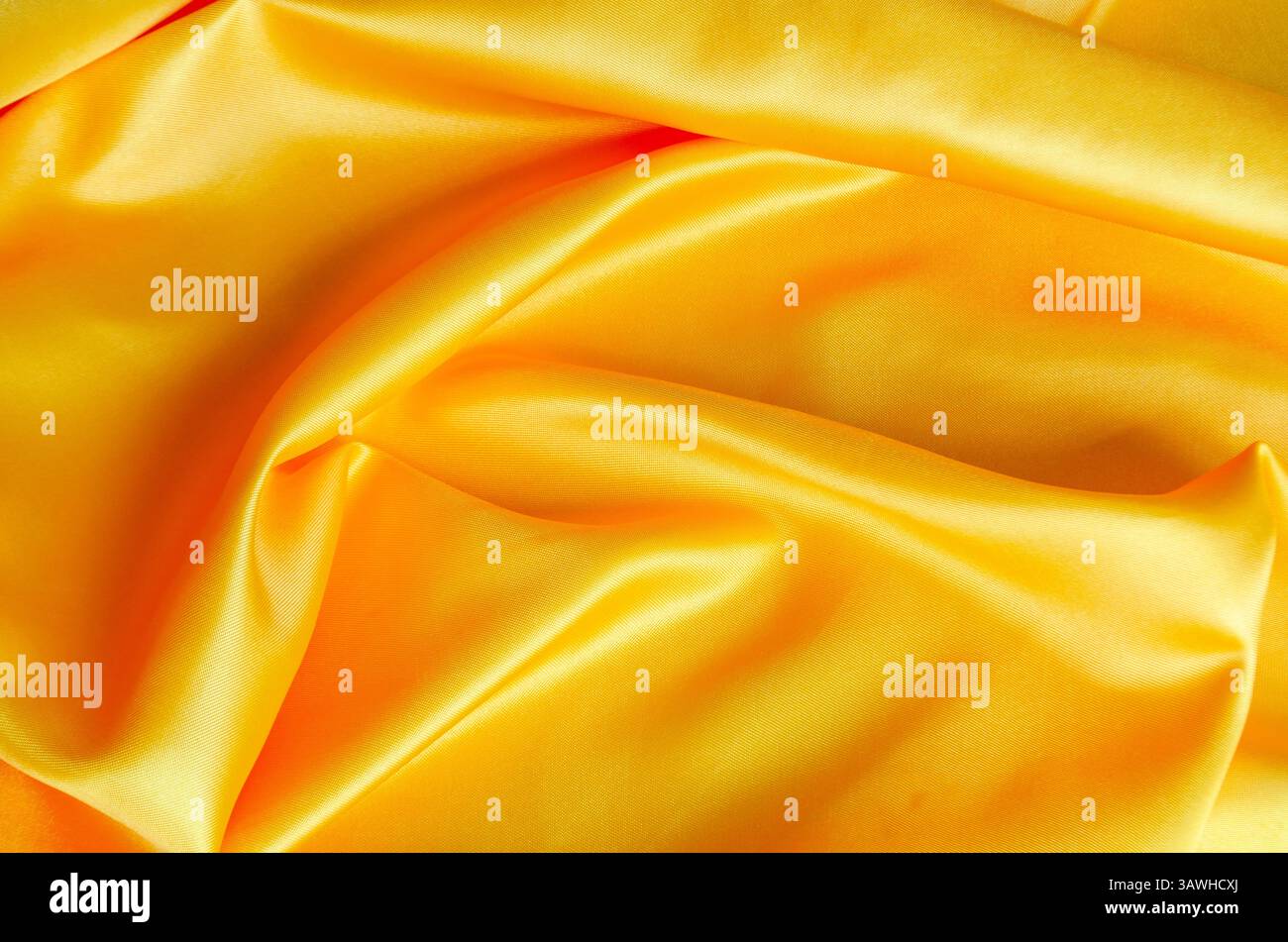 Shiny yellow satin cloth with radiant surface highlights and fine woven ...