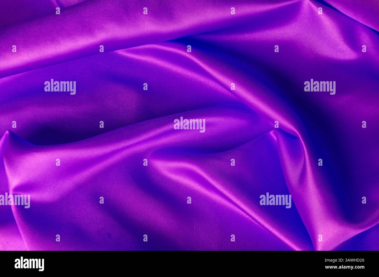 Top view of shiny maroon satin cloth with radiant surface highlights ...