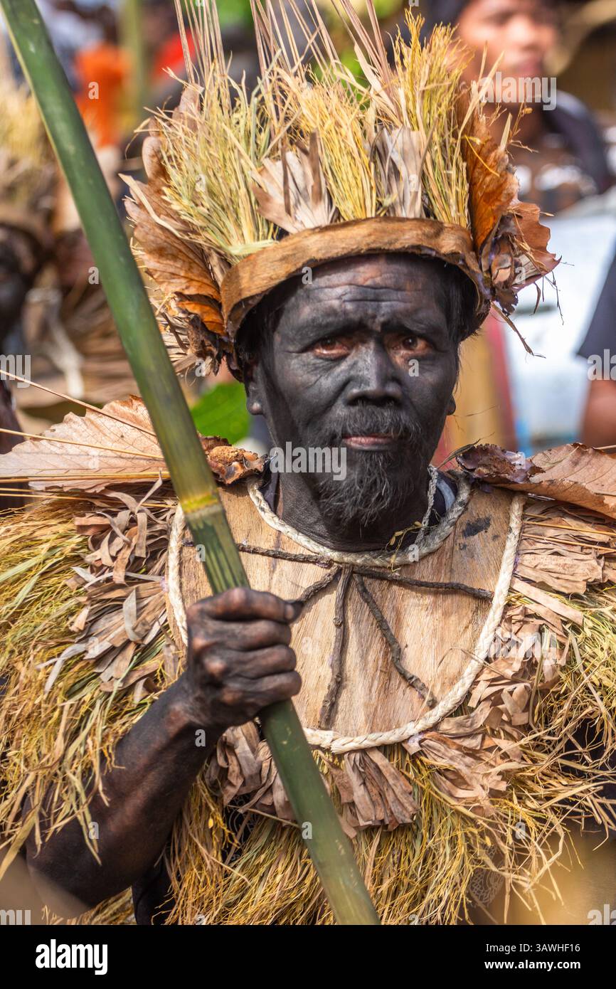 Participant in black face paint to honor the Ati tribe and wearing ...