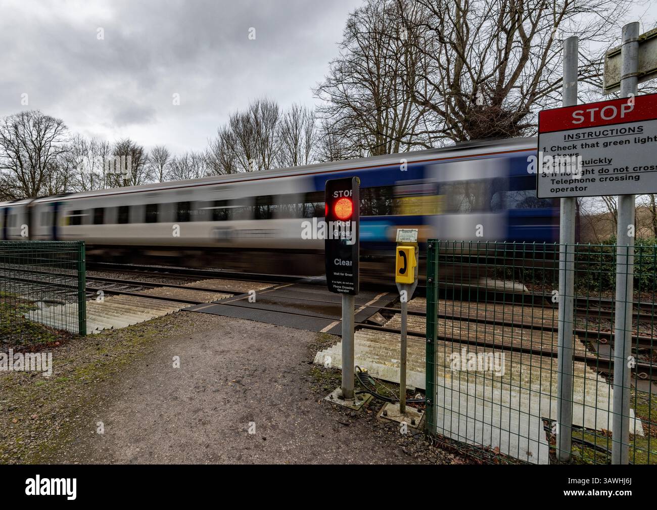 Pedestrian railway level crossing with traffic lights in rural ...