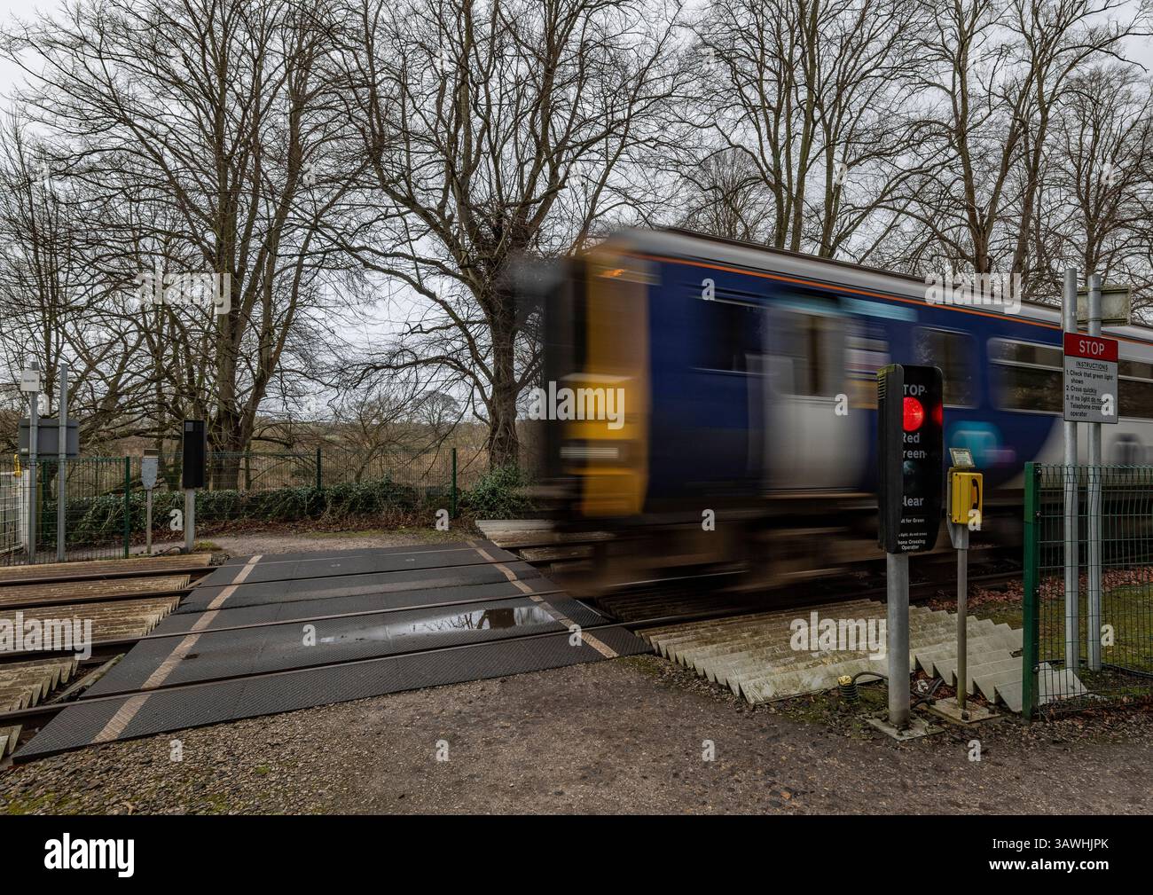 Pedestrian railway level crossing with traffic lights in rural ...