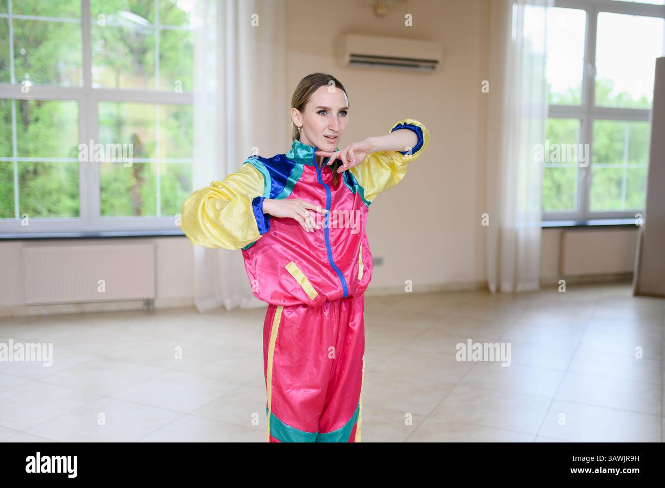 Funky dance training in studio. Young woman in stage clothes dancing in ...