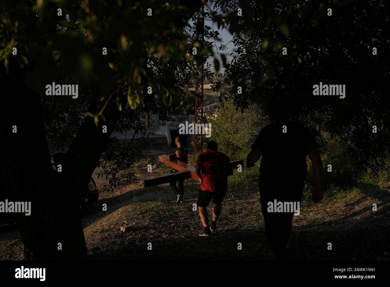Members of the Maronite Church of St. George carry a wooden cross ...