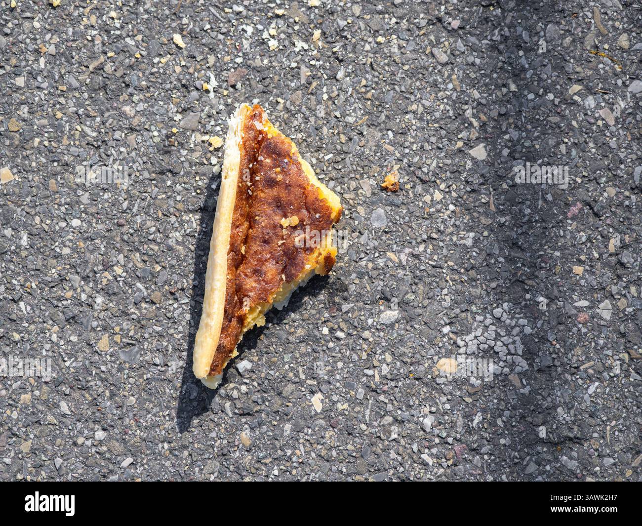 A slice of pizza with toppings on asphalt, casting a shadow Stock Photo ...