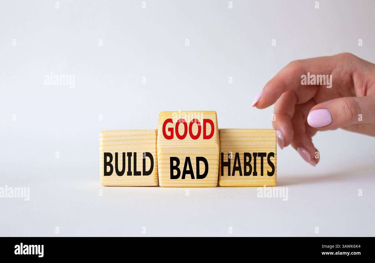 Build Good or Bad Habits symbol. Businessman hand points at wooden ...