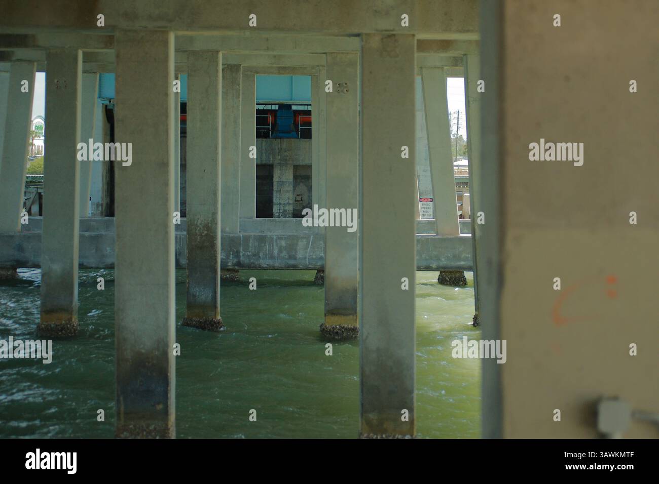Urban Draw Bridge Support Columns Over Green Water in a Modern ...