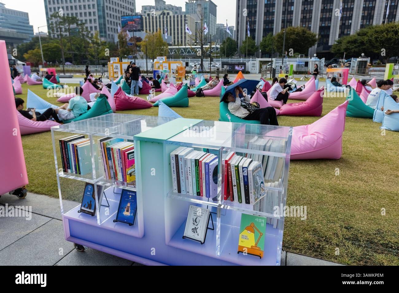 Outdoor library on the green lawn people sitting and reading books on ...