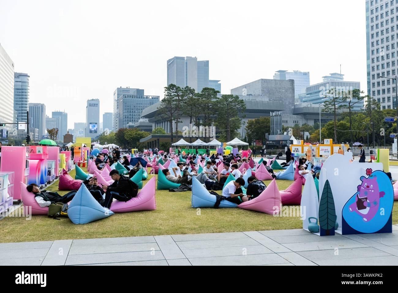 Outdoor library on the green lawn people sitting and reading books on ...