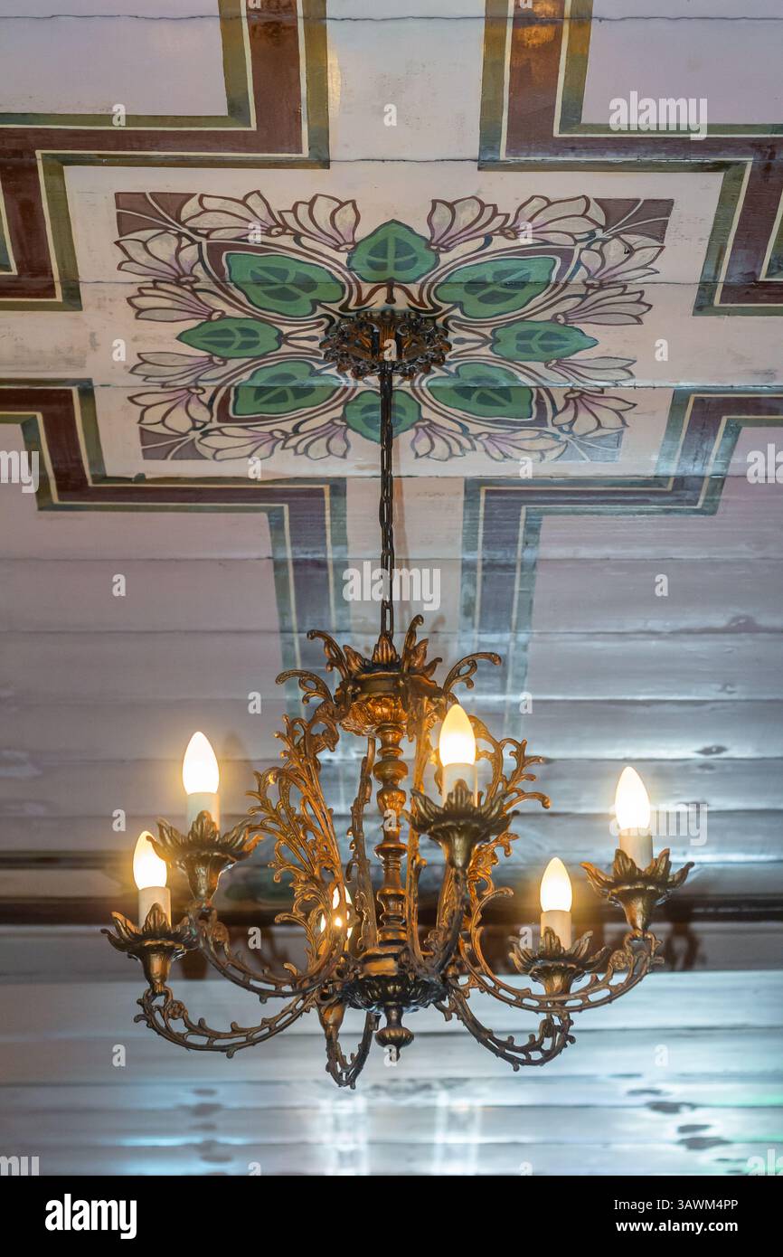 An old chandelier hangs from the ceiling of a traditional Filipino ...