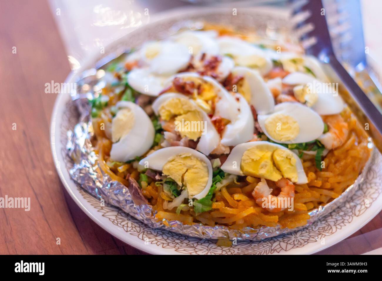 A bilao filled with Pancit Malabon, a rich and flavorful noodle dish ...