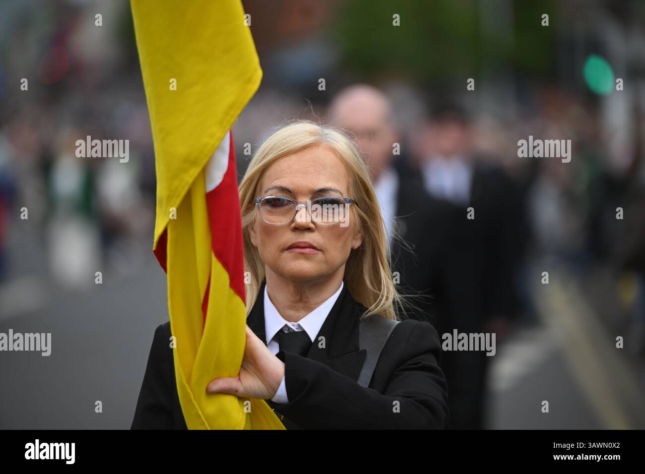 A member of the colour party on the Falls Road during a parade in ...