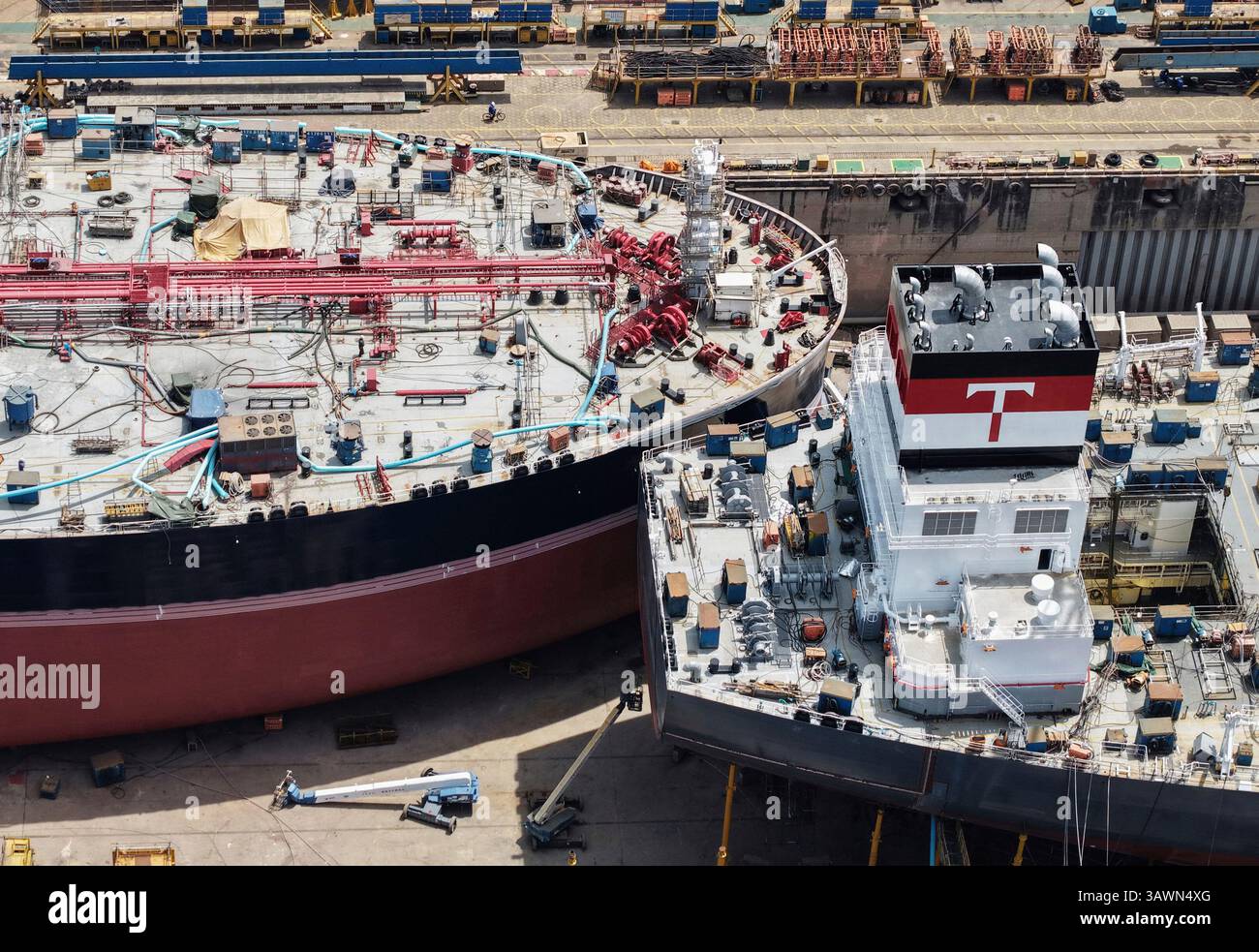Workers labor on the ships under construction at the Shanghai Shipyard ...
