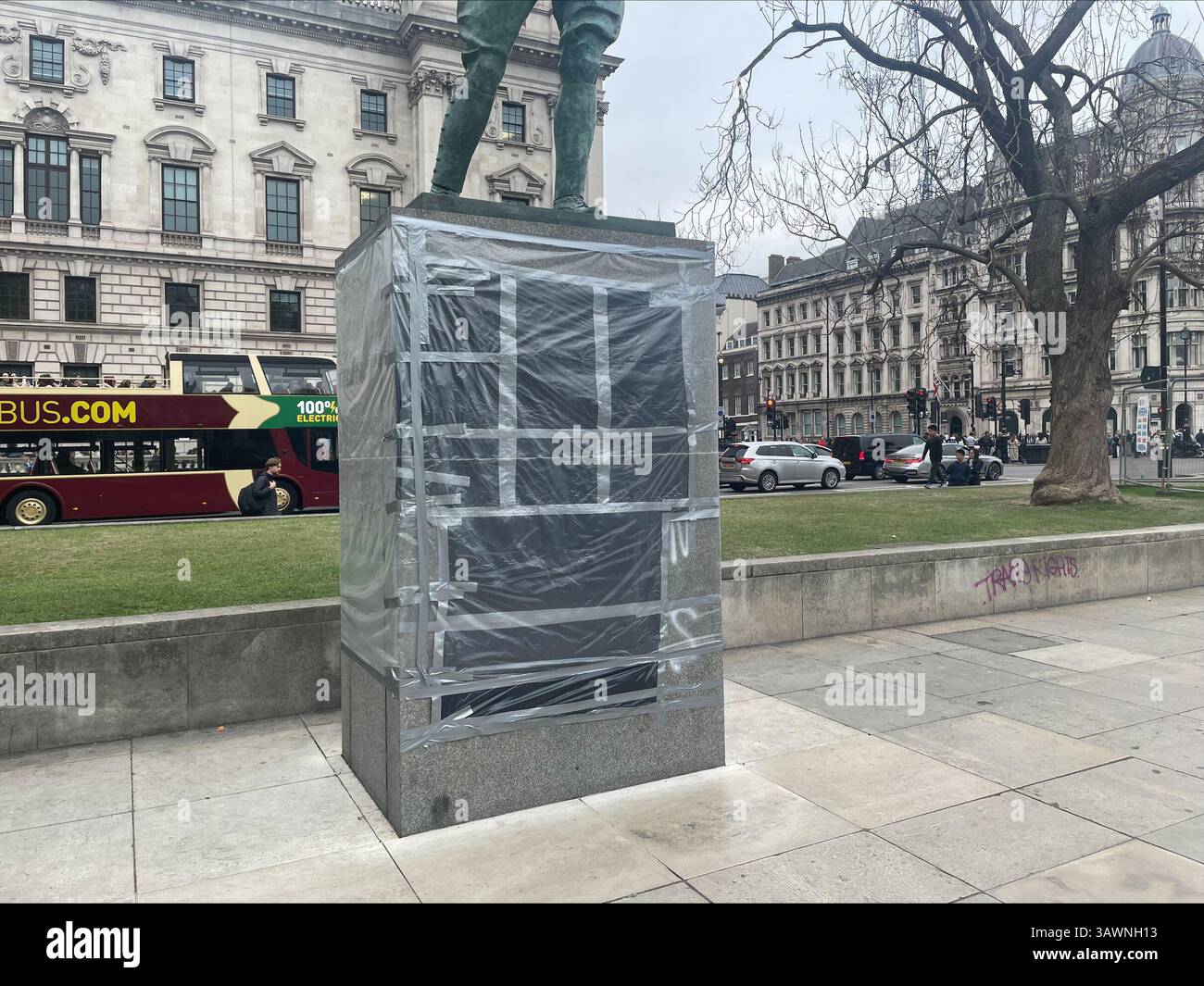 Taped plastic sheeting covers graffiti left on a statue of Jan ...