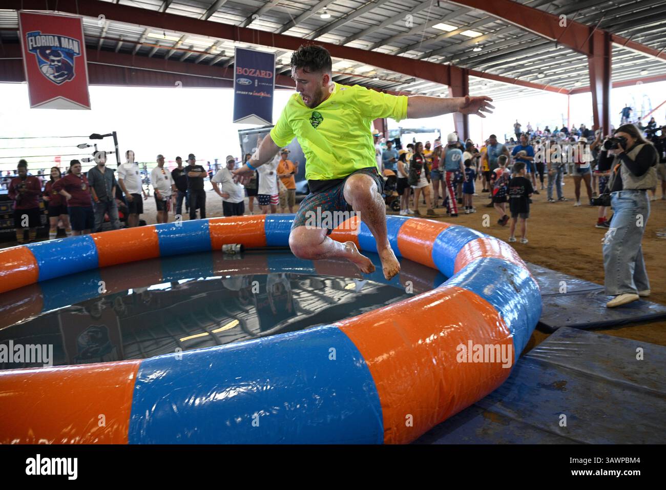 Zach Reynolds, of Tampa, Fla., jumps into a pool after losing his round ...