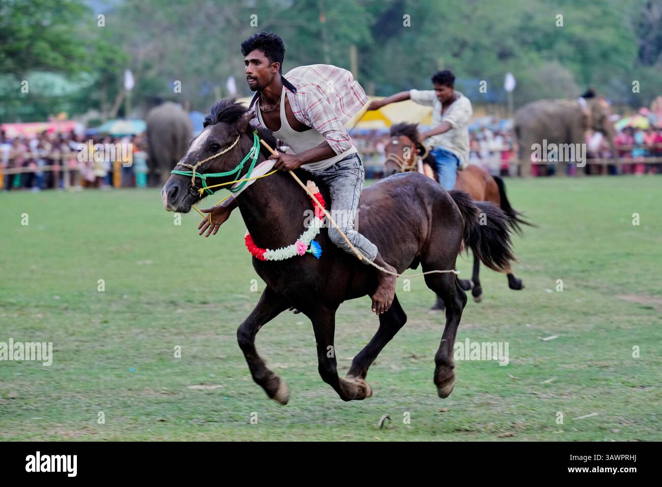 People watch a traditional horse race as part of the Suori tribal ...