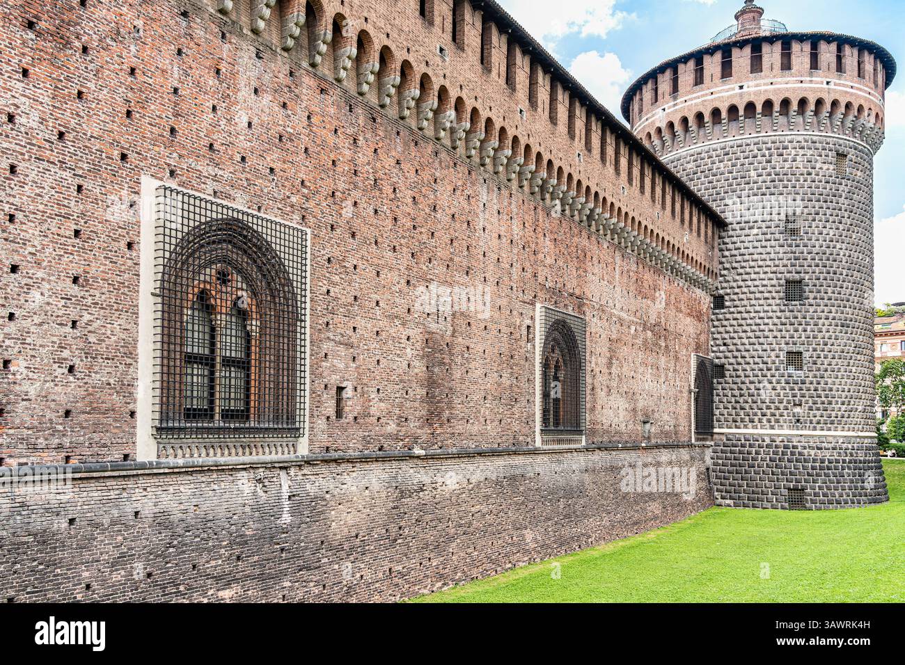 A wide-angle view of the fortified red brick walls and a cylindrical ...