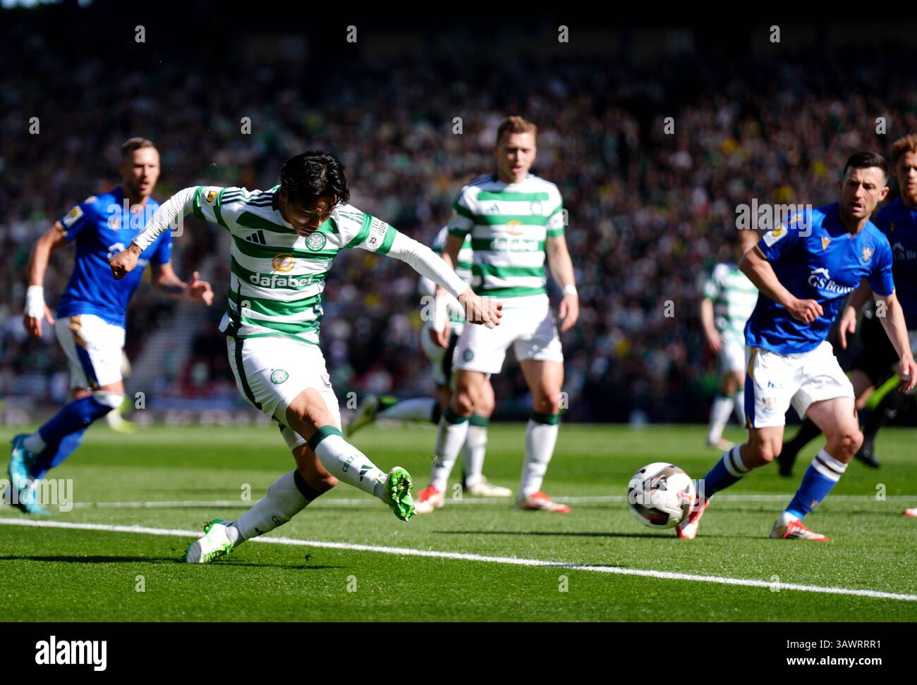 Celtic's Reo Hatate (left) has a shot at goal during the Scottish Gas ...