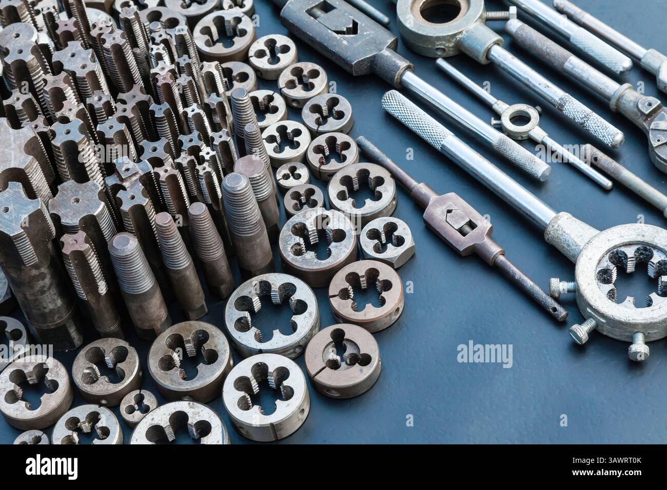 Taps, dies and wrenches for taps and dies on a black background. Manual ...