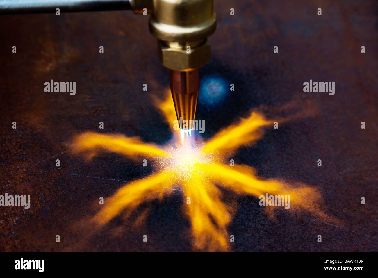 Gas cutting of metal. Gas cutter with copper nozzle with a stream of ...