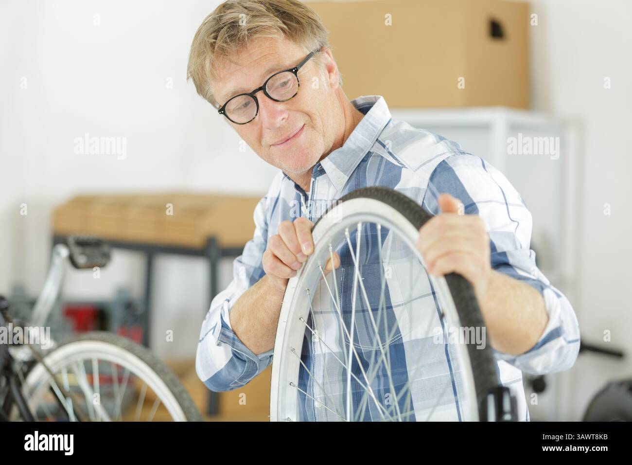 a mature man repairing cycle Stock Photo - Alamy