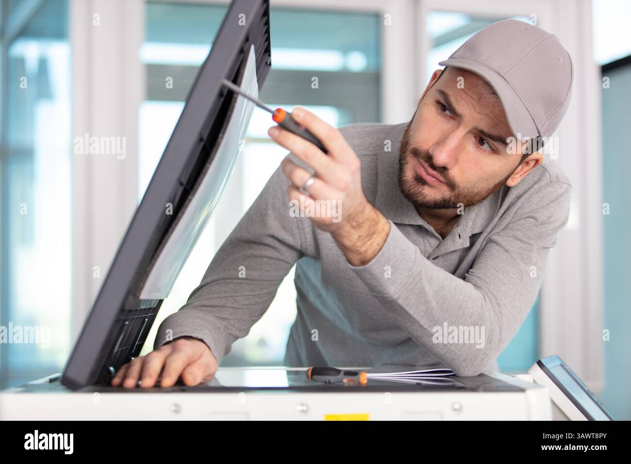 hardware repairman repairing broken printer fax machine Stock Photo - Alamy