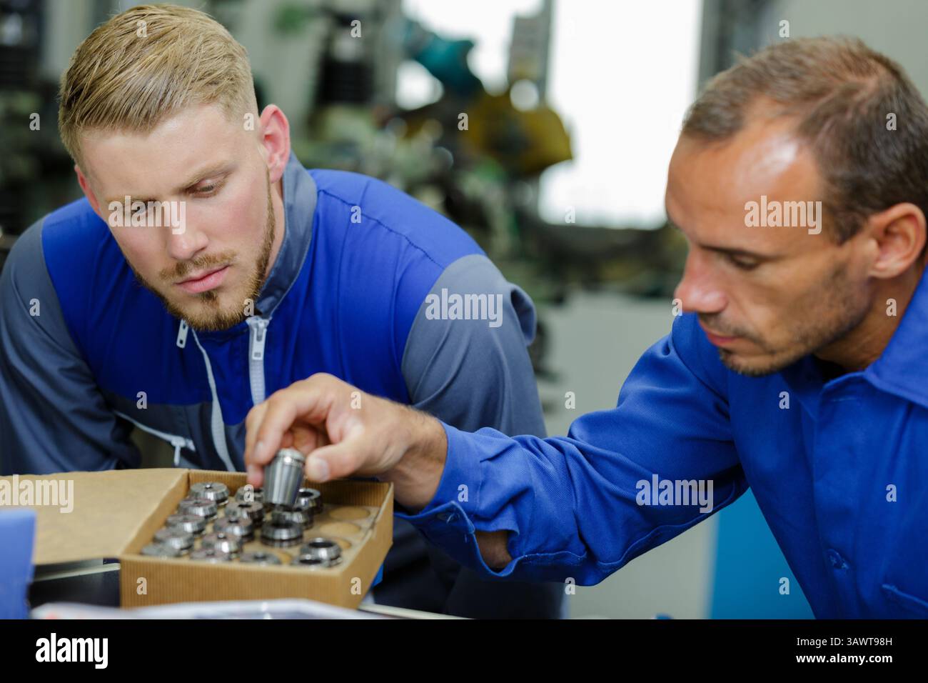 two metal cogged wheels on steel background Stock Photo - Alamy