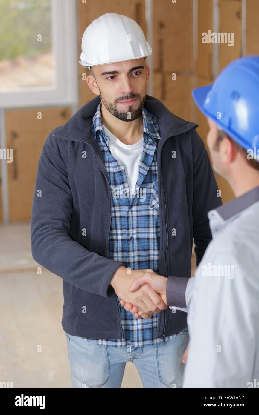 portrait of contractors shaking hands Stock Photo - Alamy
