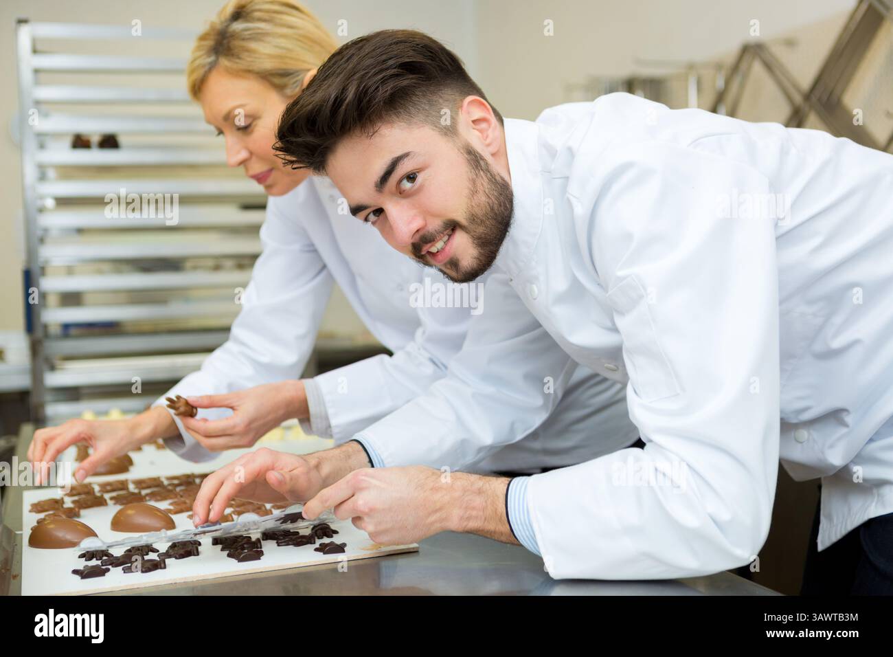 professional chefs assembling chocolate shapes Stock Photo - Alamy