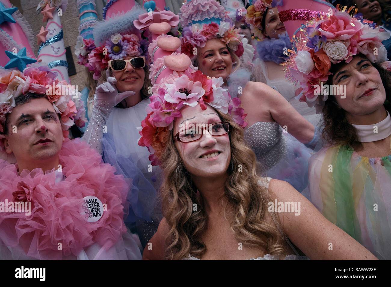 Revelers wearing decorated hats and costumes participate in the annual ...