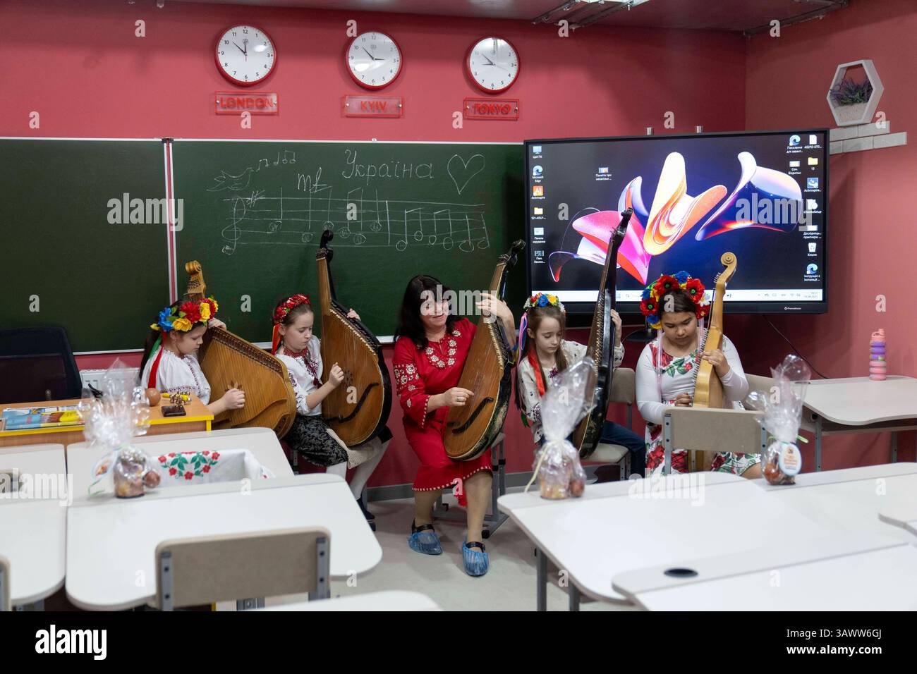 Students perform a song on the Bandura, a Ukrainian, plucked string, folk instrument on Easter ...