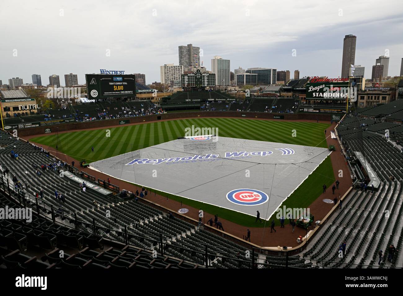 A rain tarp covers the infield at Wrigley Field during a rain delay ...