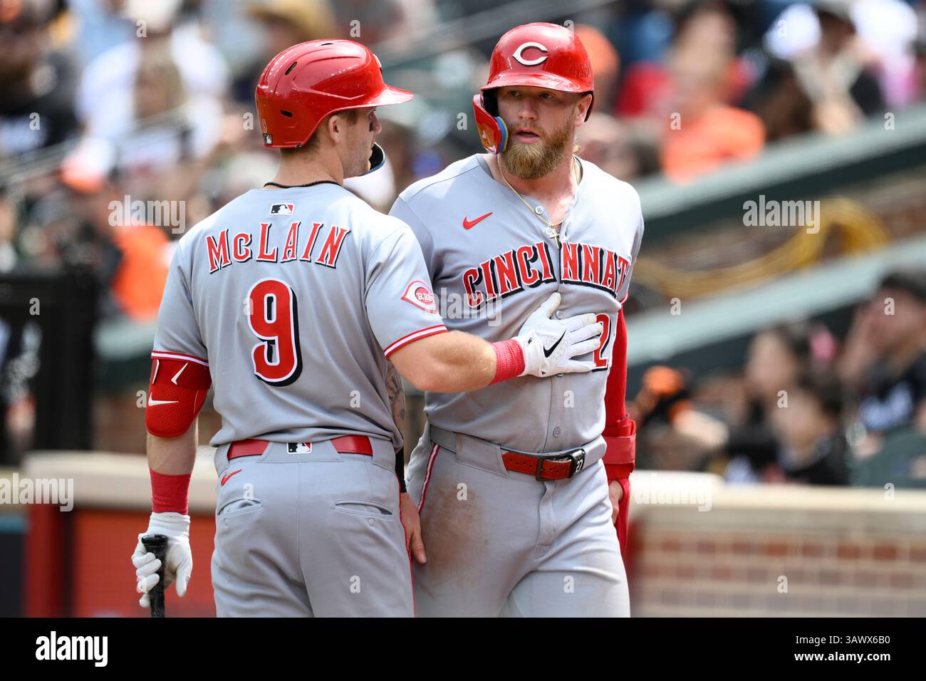 Cincinnati Reds' Jake Fraley, right, is greeted by teammate Matt McLain ...
