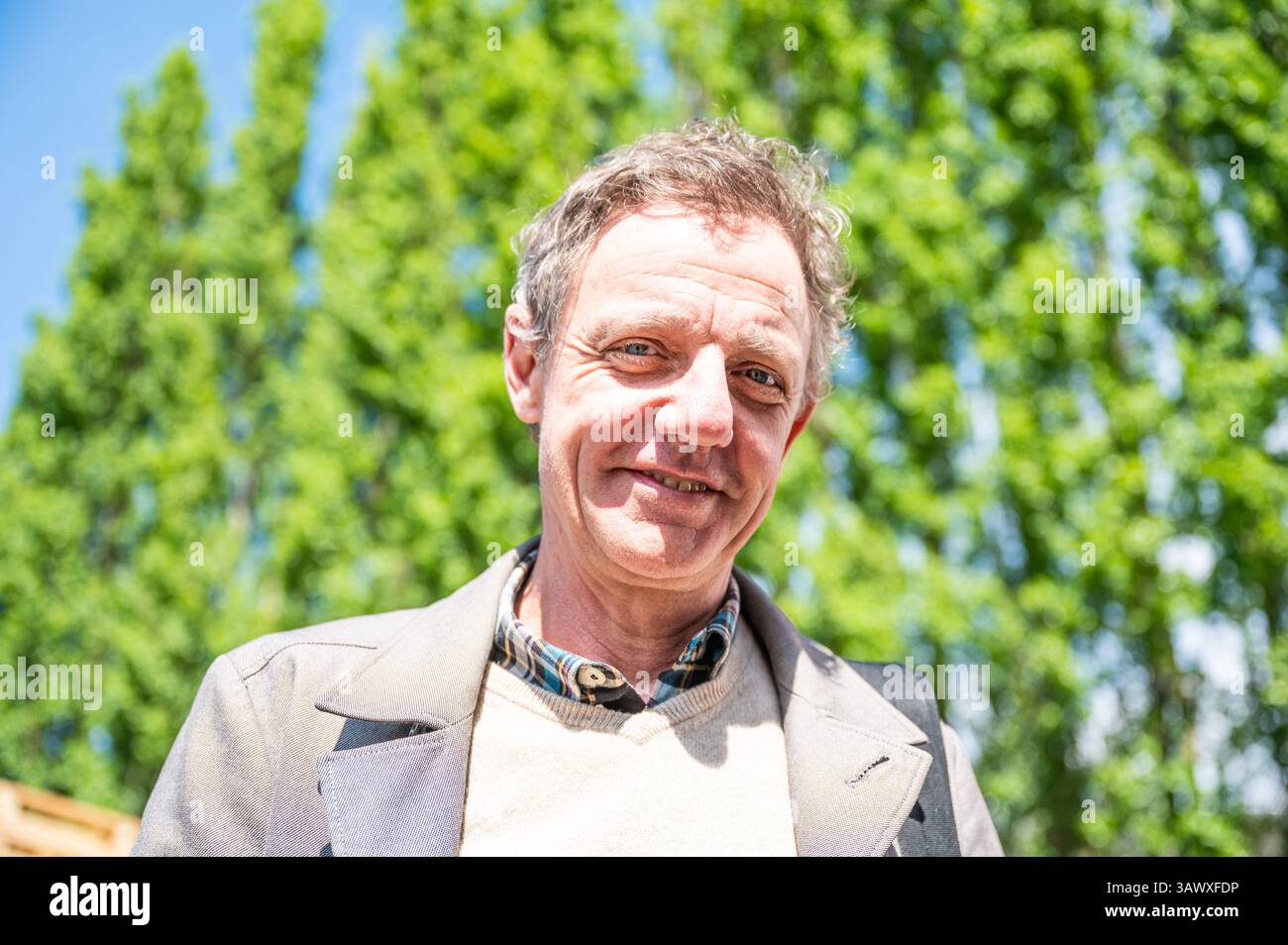 Outdoor portrait of a 57 yo white man, wearing a blaser vest ...