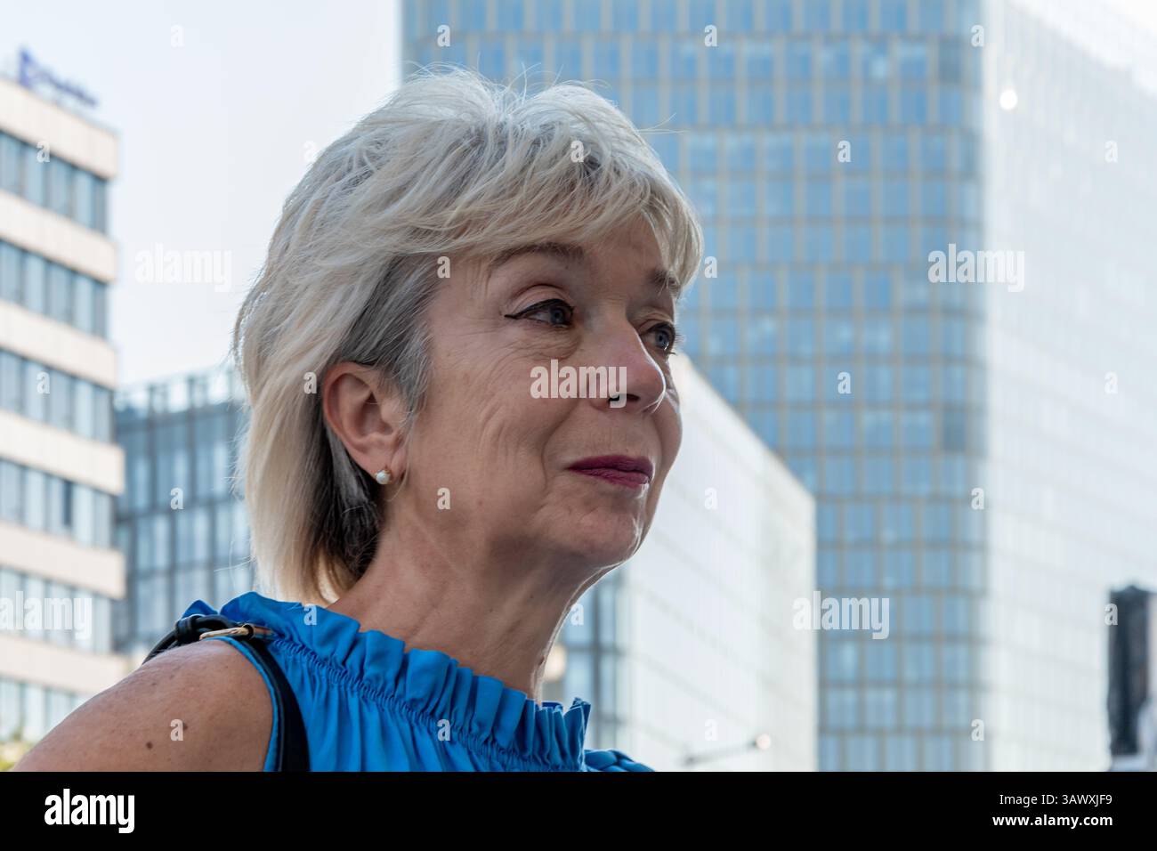 Street portrait of an elderly woman aged 65-70 against a background of ...