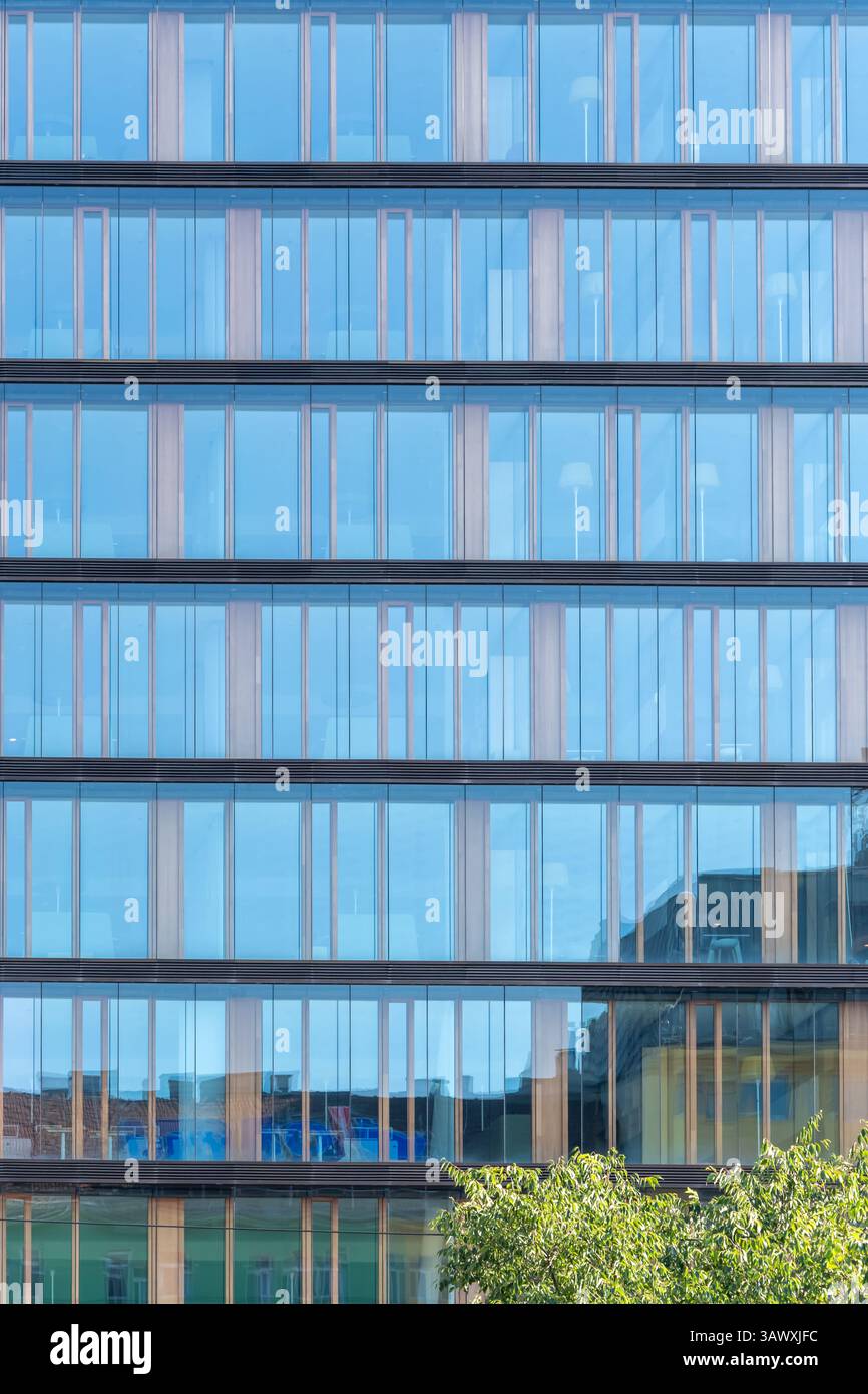 Modern glass office building with reflections and rhythmic façade ...