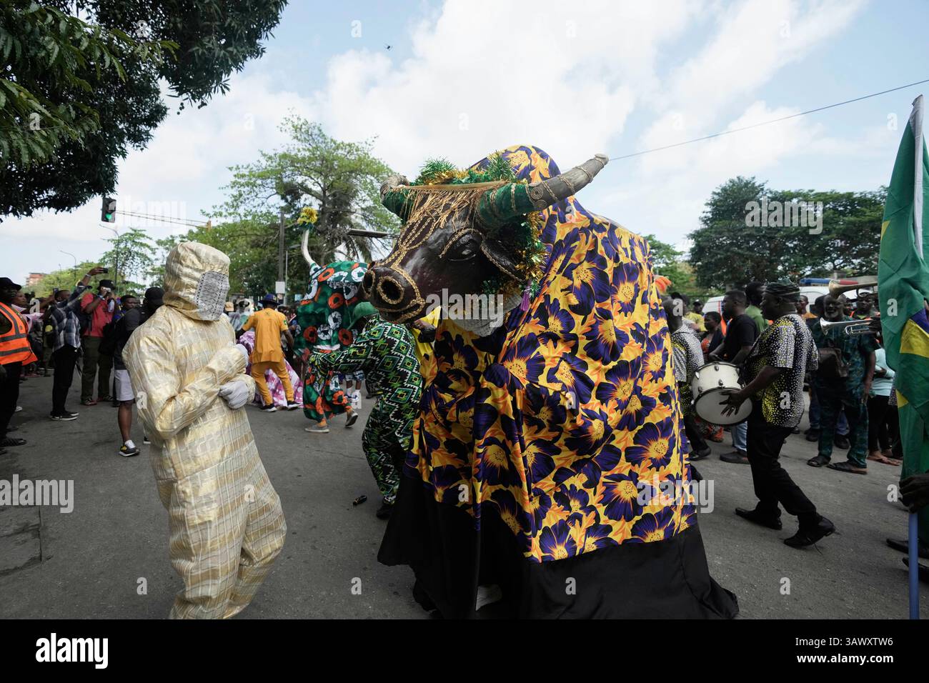 People in costumes dance on the street during the Fanti Carnival in ...
