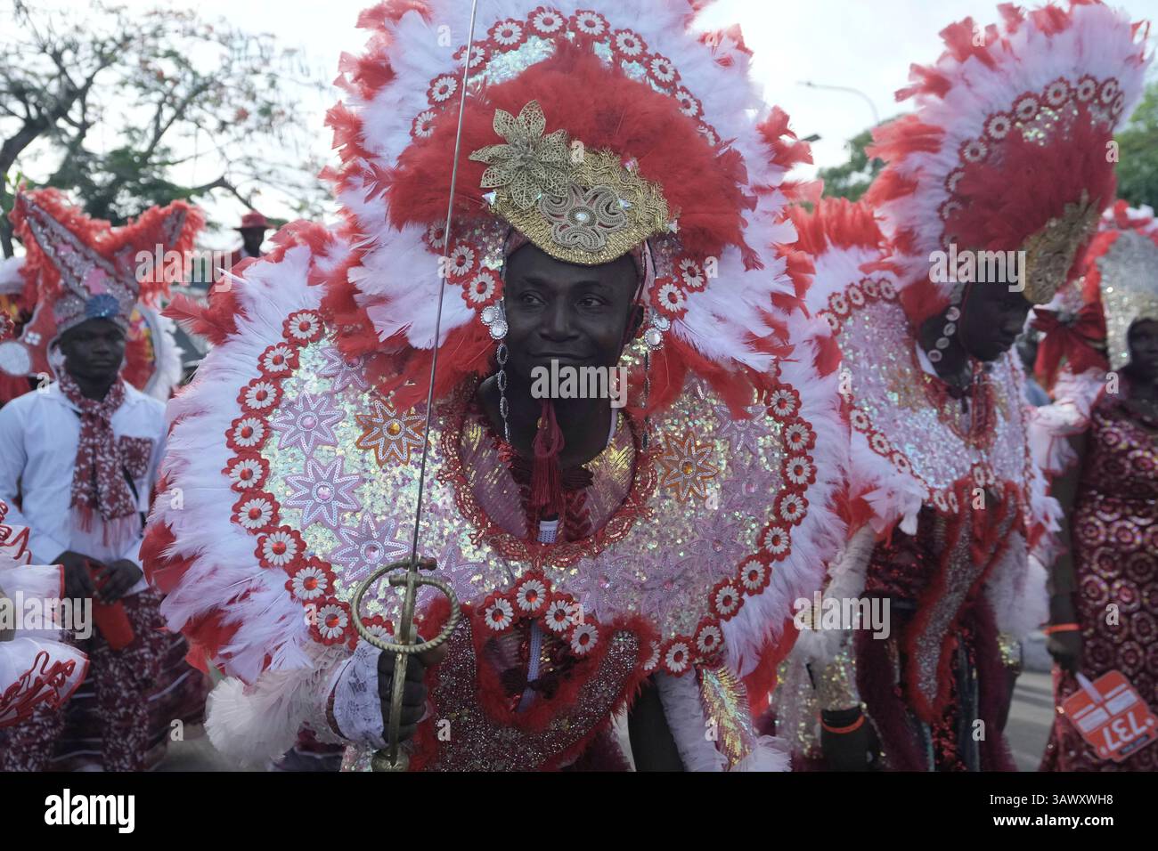 People in costumes dance on the street during the Fanti Carnival in ...