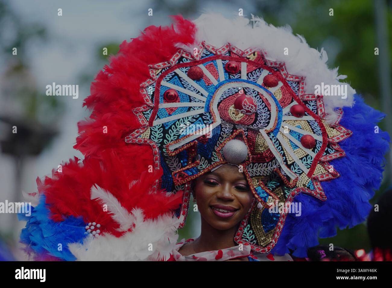 A woman in costume dances on the street during the Fanti Carnival in ...