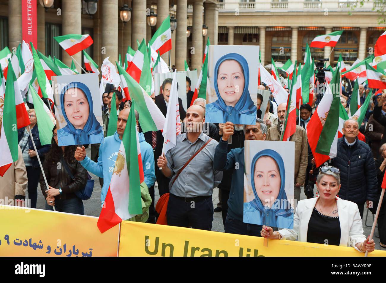 Protesters with flags and banners, and pictures of Maryam Rajavi, the ...