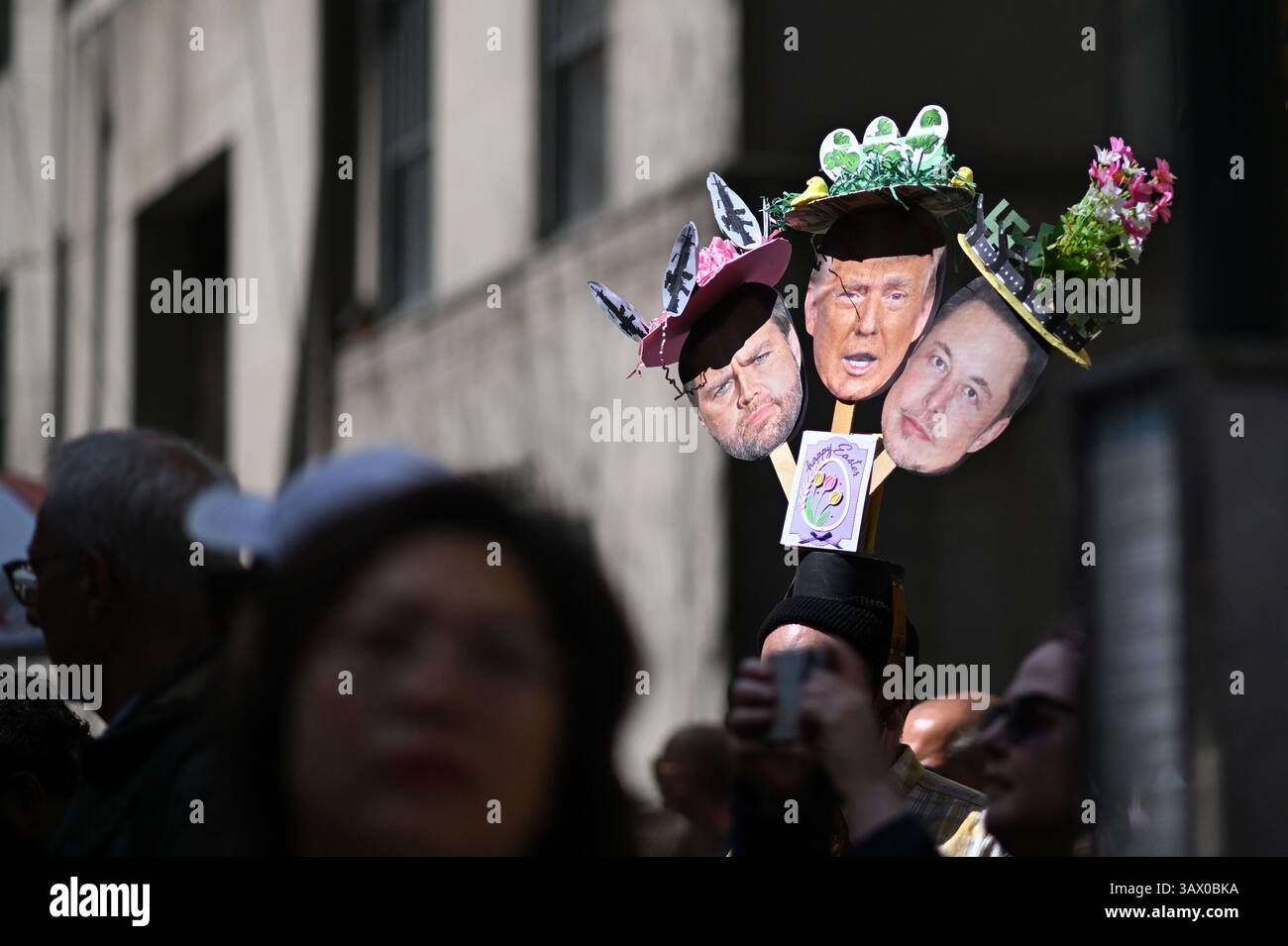 New York, USA. 20th Apr, 2025. A parade participant holds a sign with ...